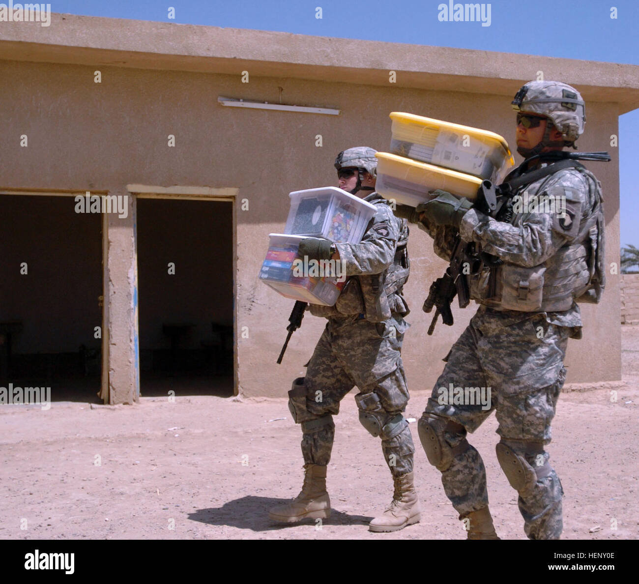 Soldiers with Troop A, 1-33rd Cavalry Regiment, carry school supplies ...
