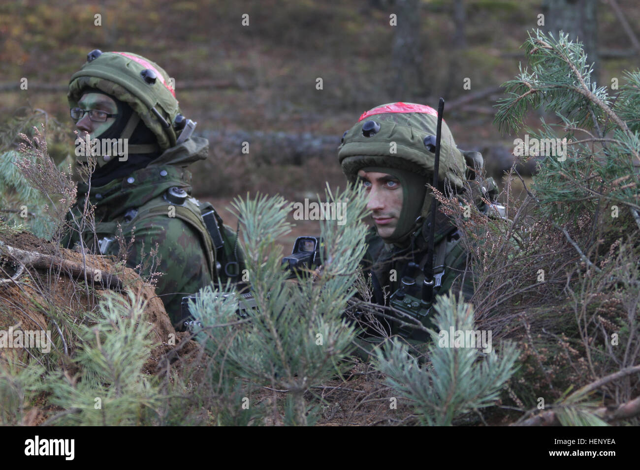 From a concealed fighting position, Lithuanian Soldiers defend against ...