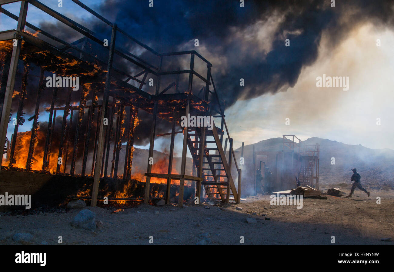 An enemy compound burns after a training scenario during Decisive ...