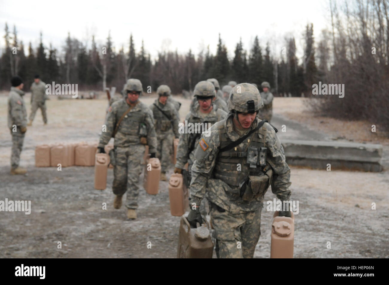 U.S. Army Alaska Soldiers carry water cans and prepare during the ...