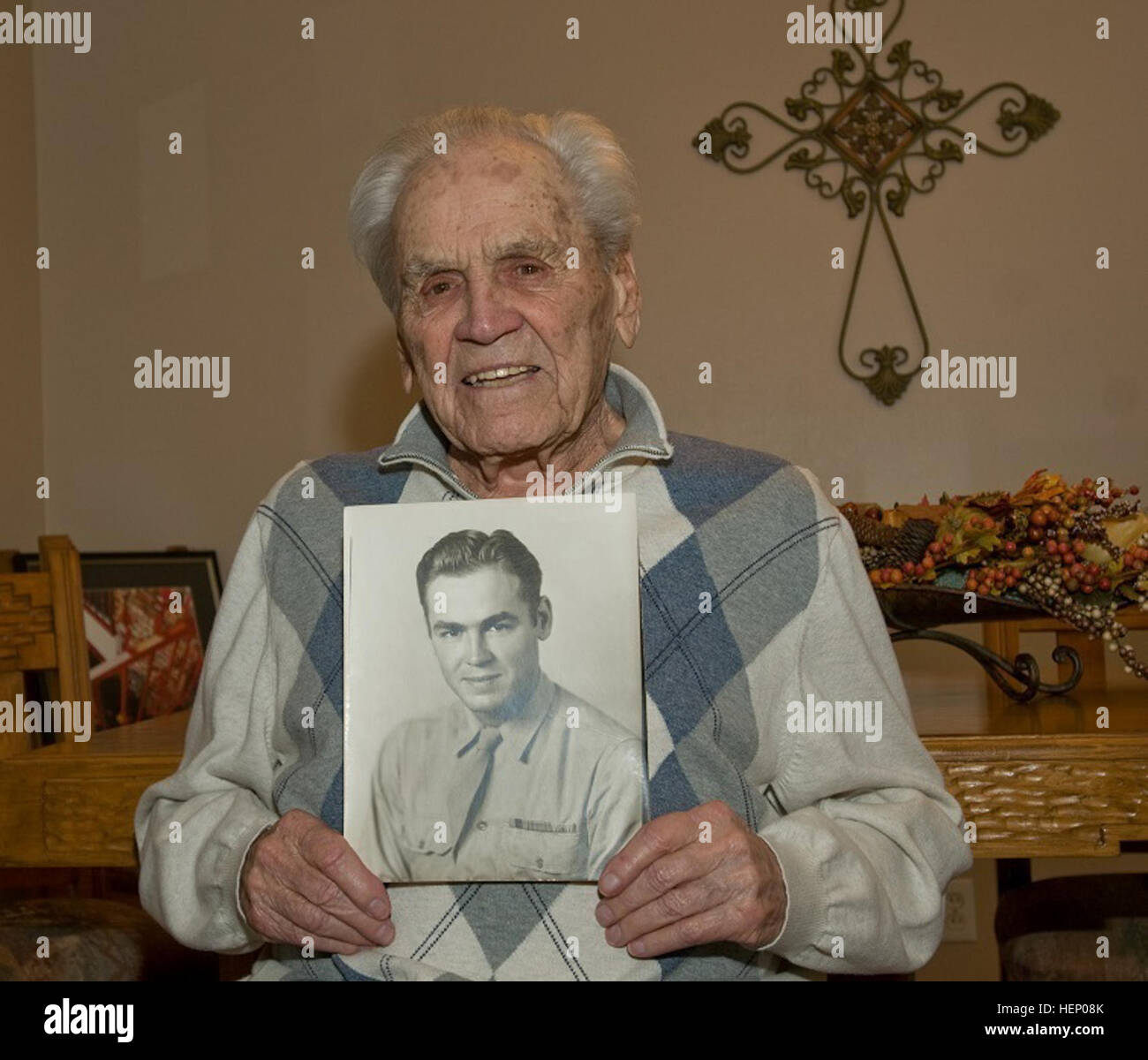 Harry Brodie, a WWII veteran, holds a picture of himself when he was a ...