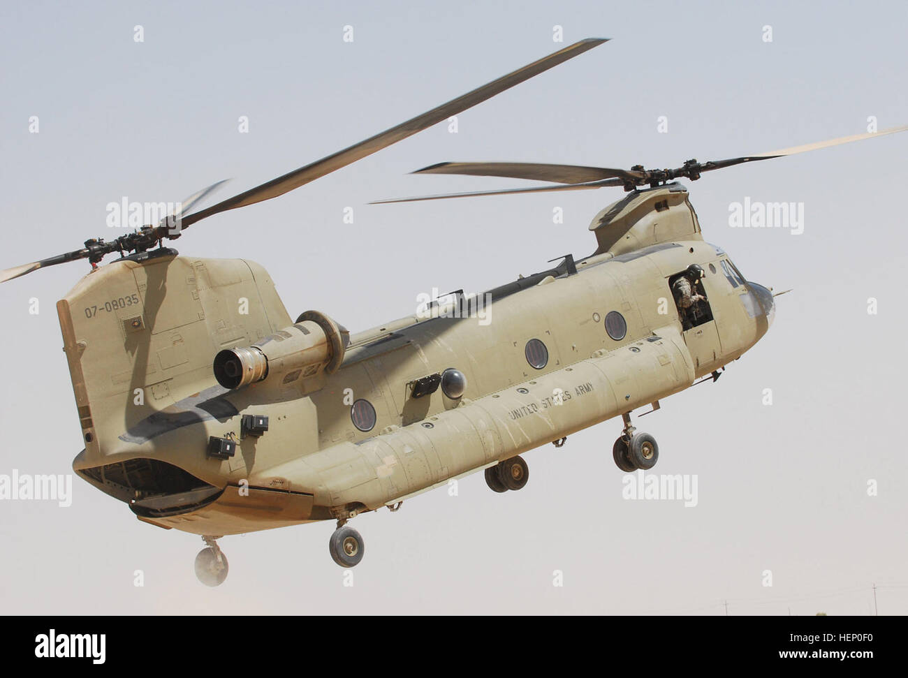 A CH-47 Chinook helicopter prepares to land in the desert region of the ...