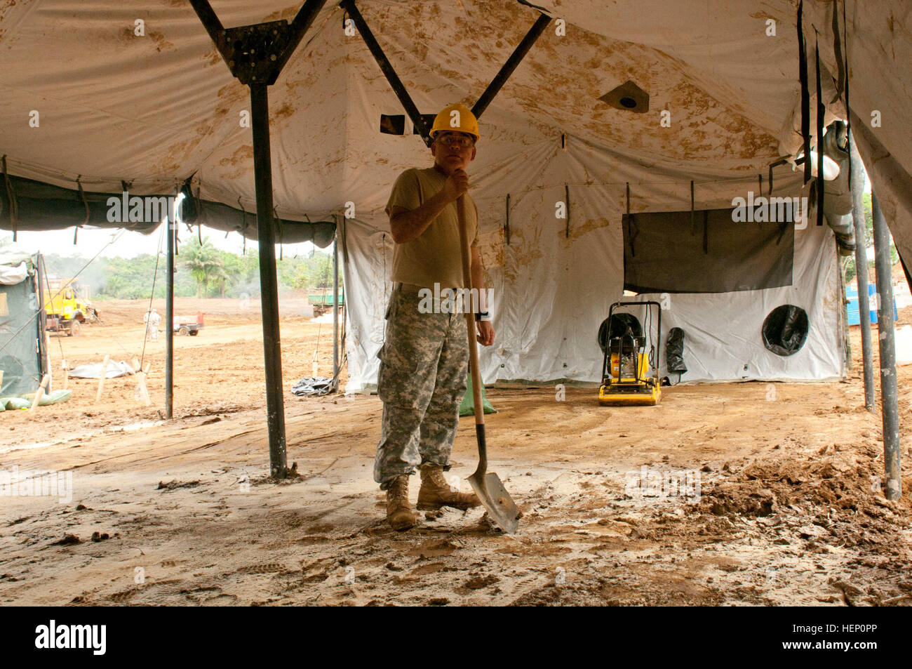 Sgt. Jesse Fernandez from San Antonio, Texas, improves a tent that will ...