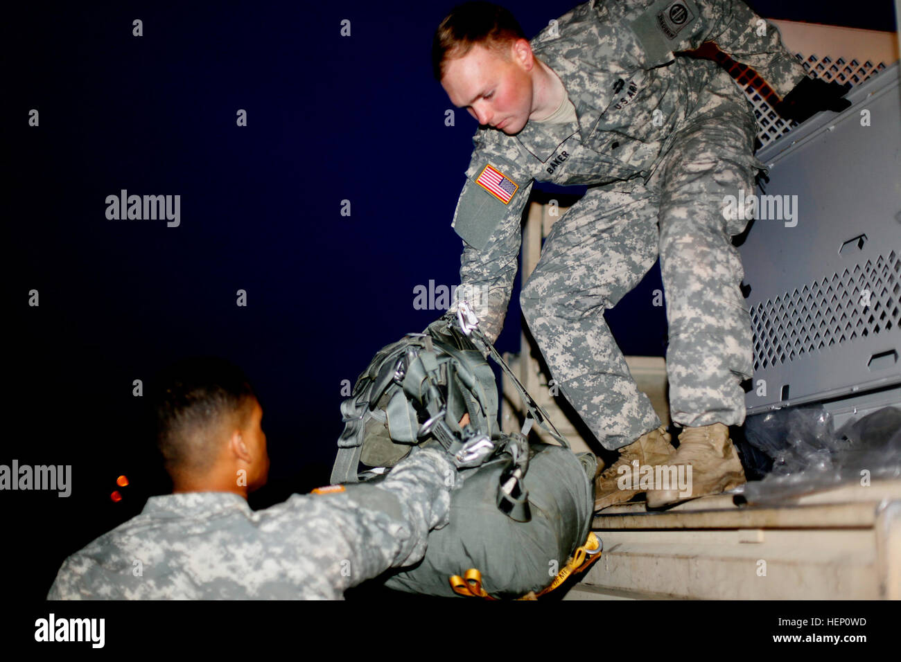 A paratrooper receives his parachute before participating in an ...