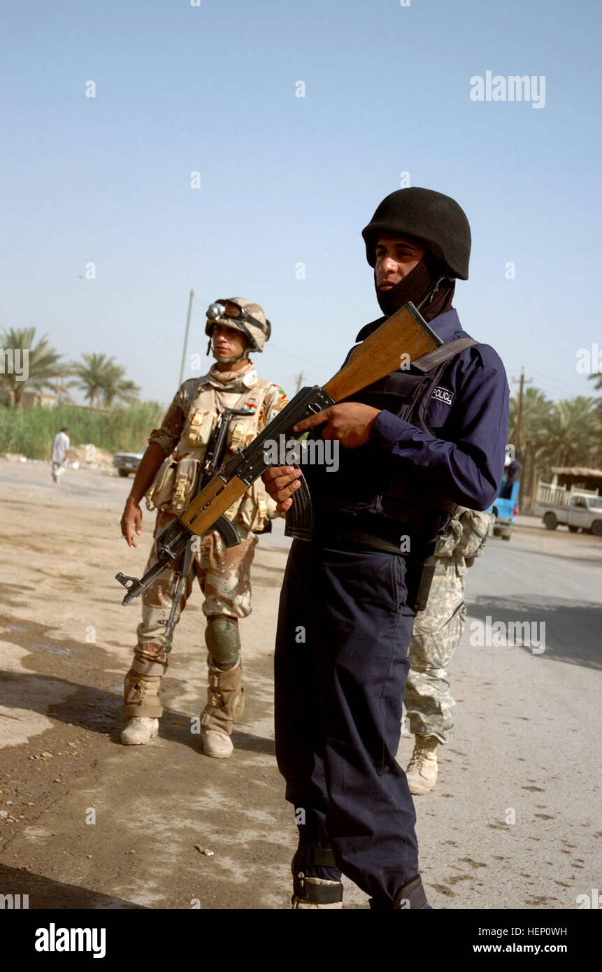 A local Iraqi police officer and an Iraqi army soldier from the 24th ...