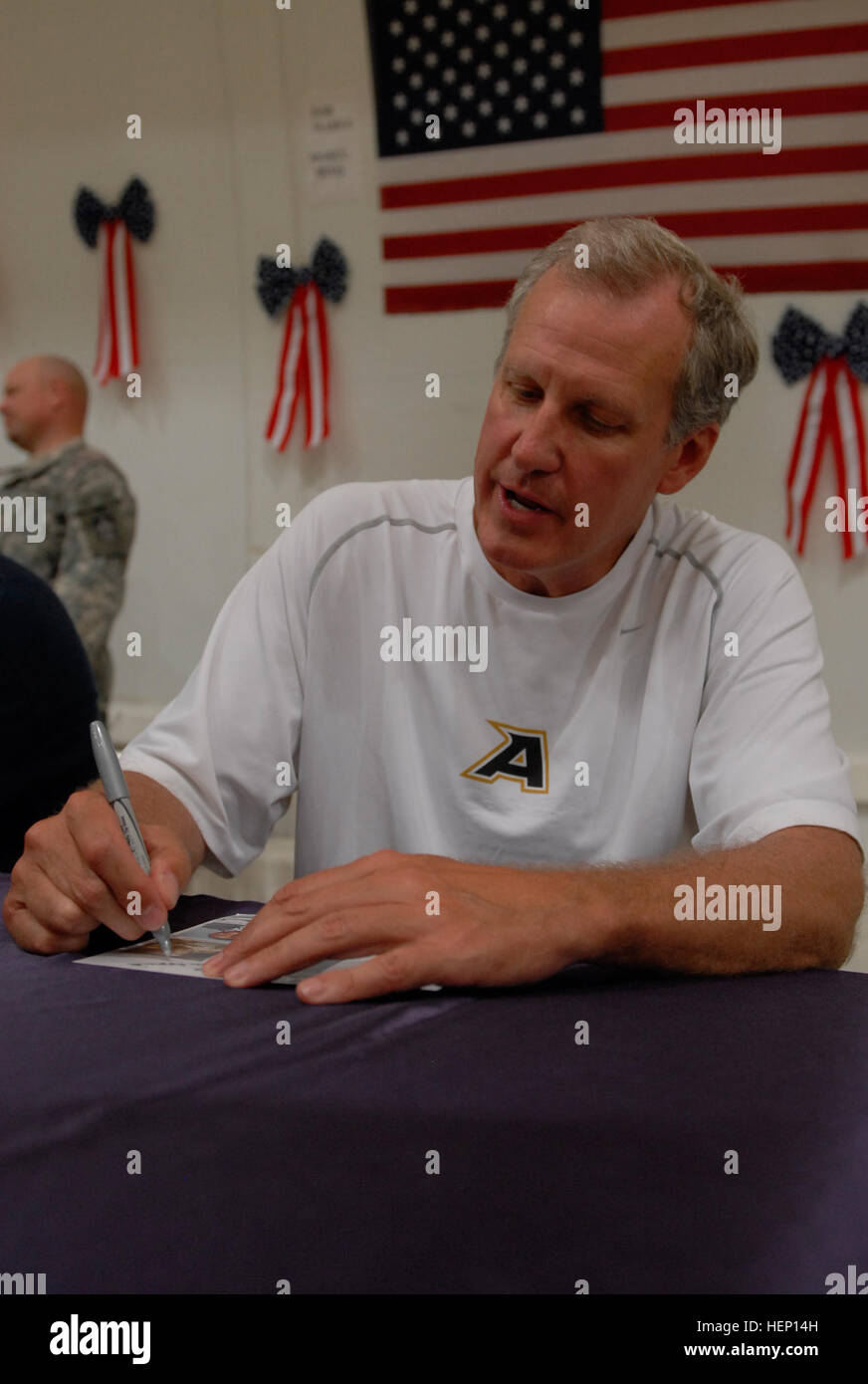 West Point basketball coach Jim Crews signs his autograph and interacts ...