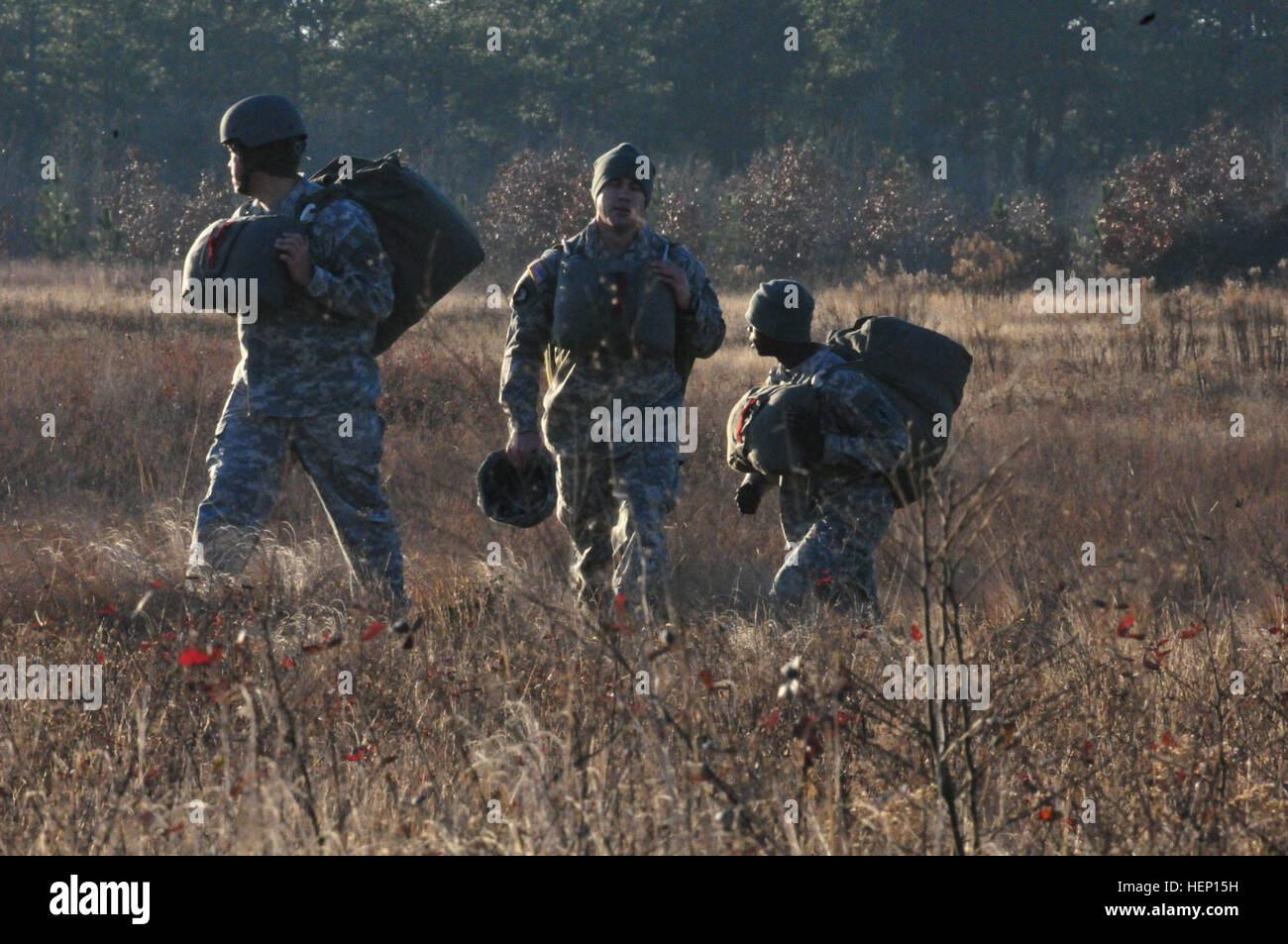 U.S. Army paratroopers make their way to the rally point after landing ...