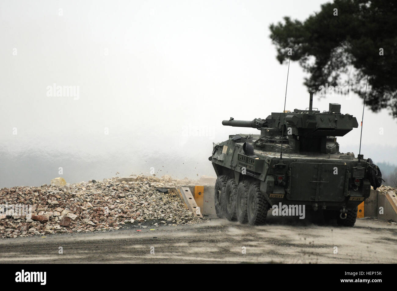 A M1128 Stryker Mobile Gun System assigned to (UNIT) fires a 105mm ...