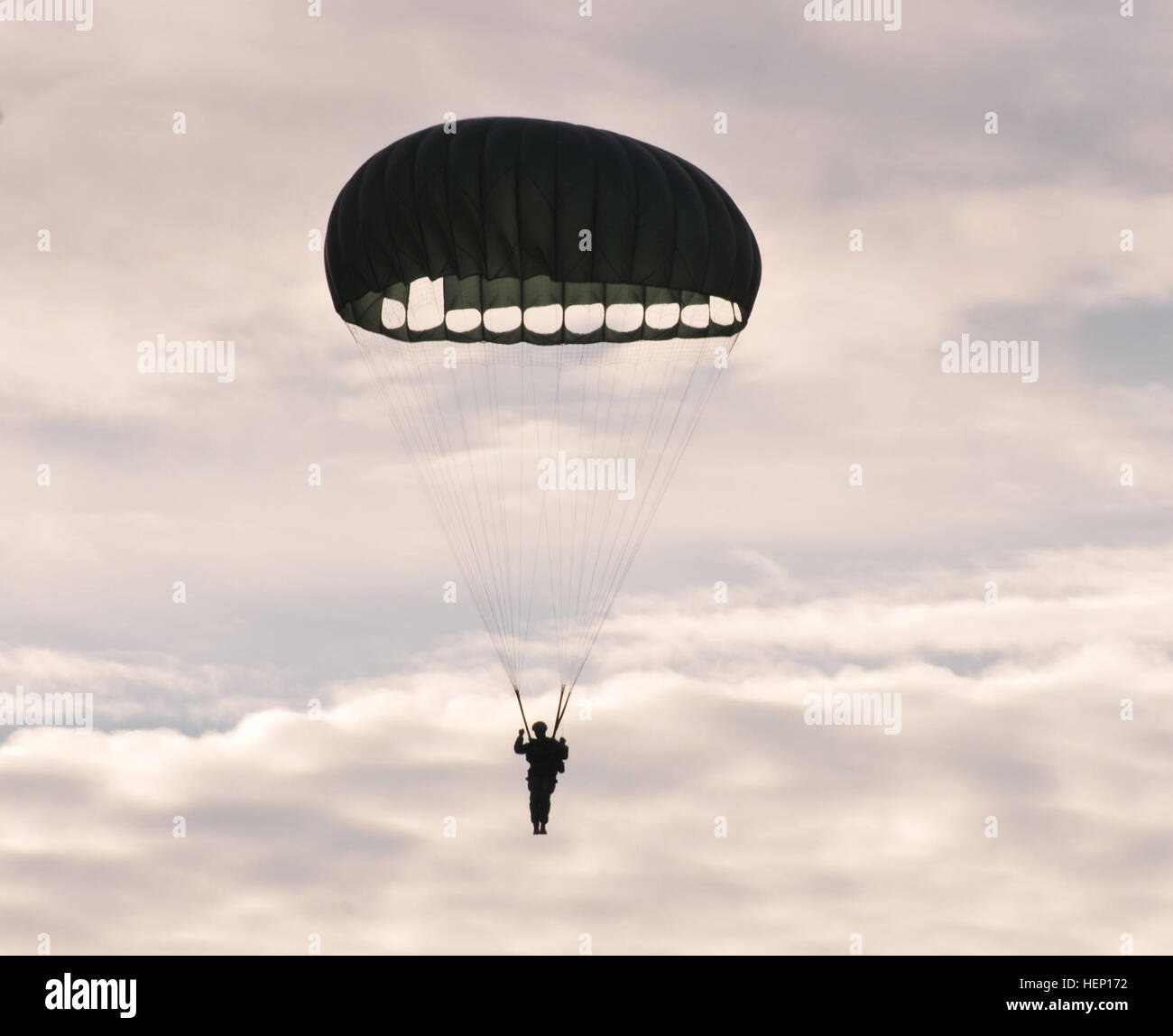 A U.S. Army paratrooper descends from an aircraft onto Luzon Drop Zone ...