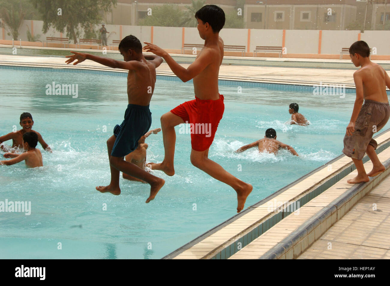 Iraqi children jump into the Al Jadida Public Swimming Pool after its ...