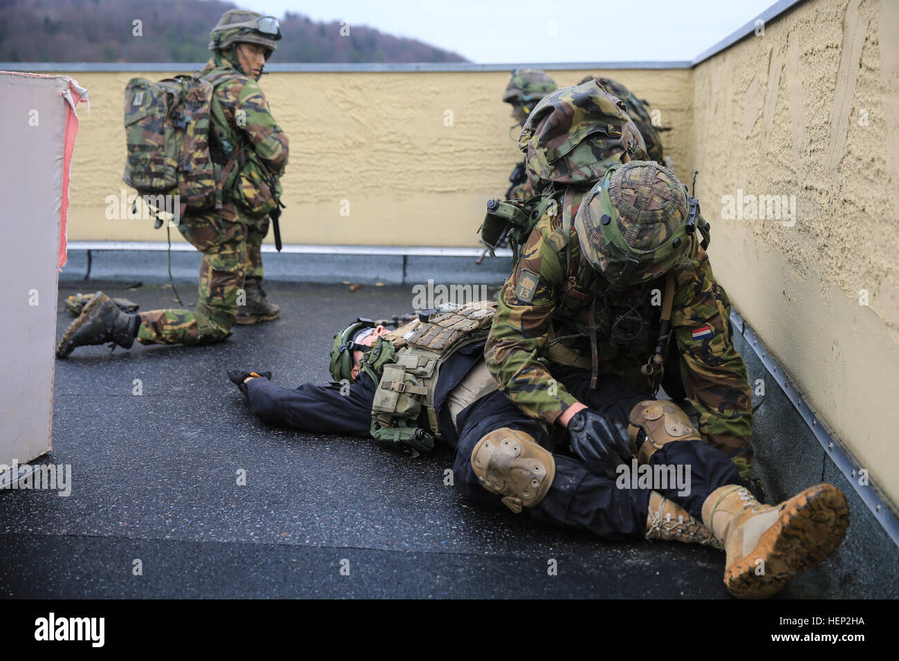 A soldier role-playing as opposing forces is searched by a Dutch ...