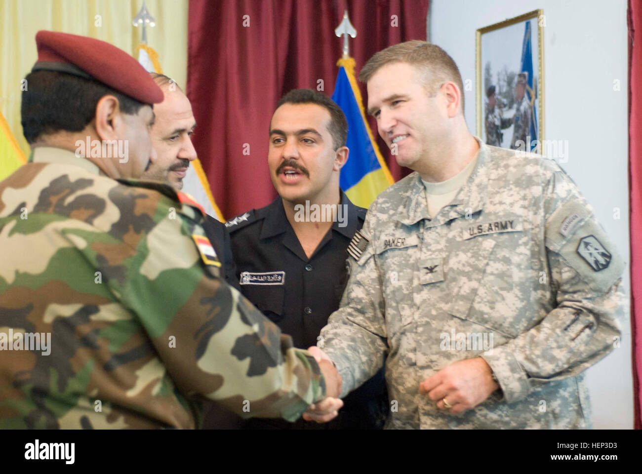 Col. Peter Baker, commander of the 214th Fires Brigade, shakes hands ...