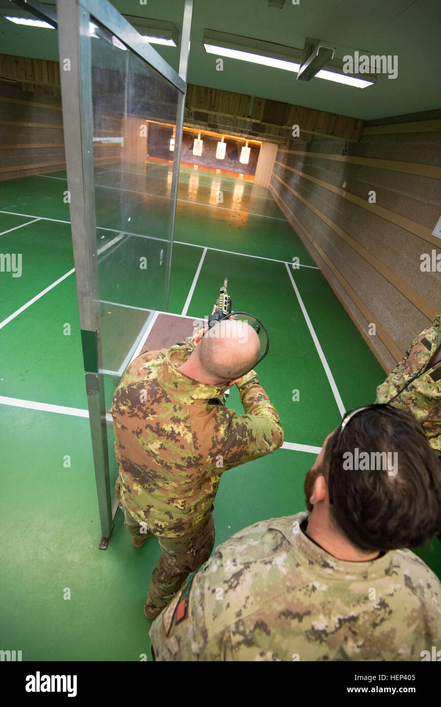 An Italian paratrooper trains with an M4 carbine at the 25-meter range ...