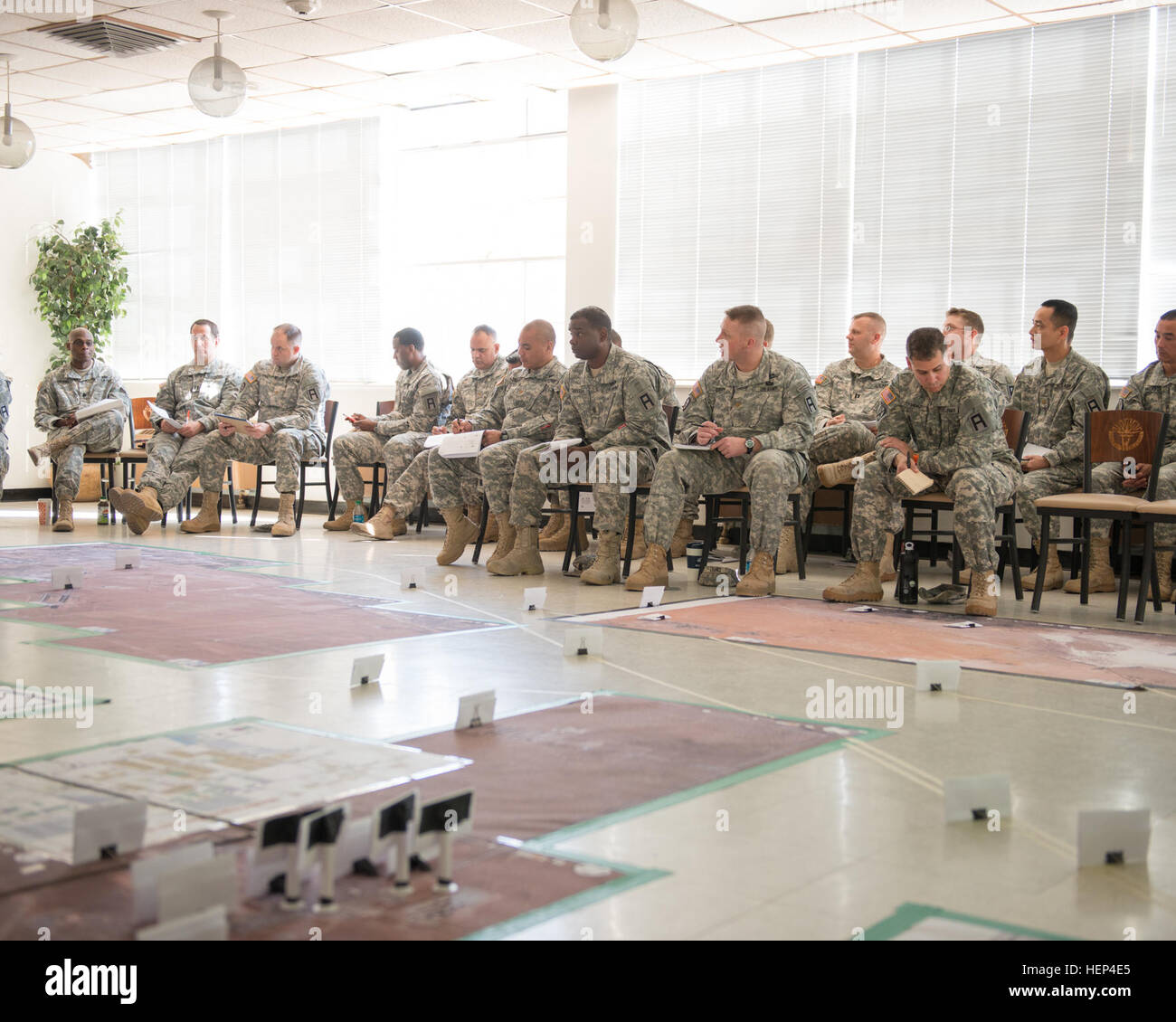 Staff members from the 402nd Field Artillery Brigade take notes and ...