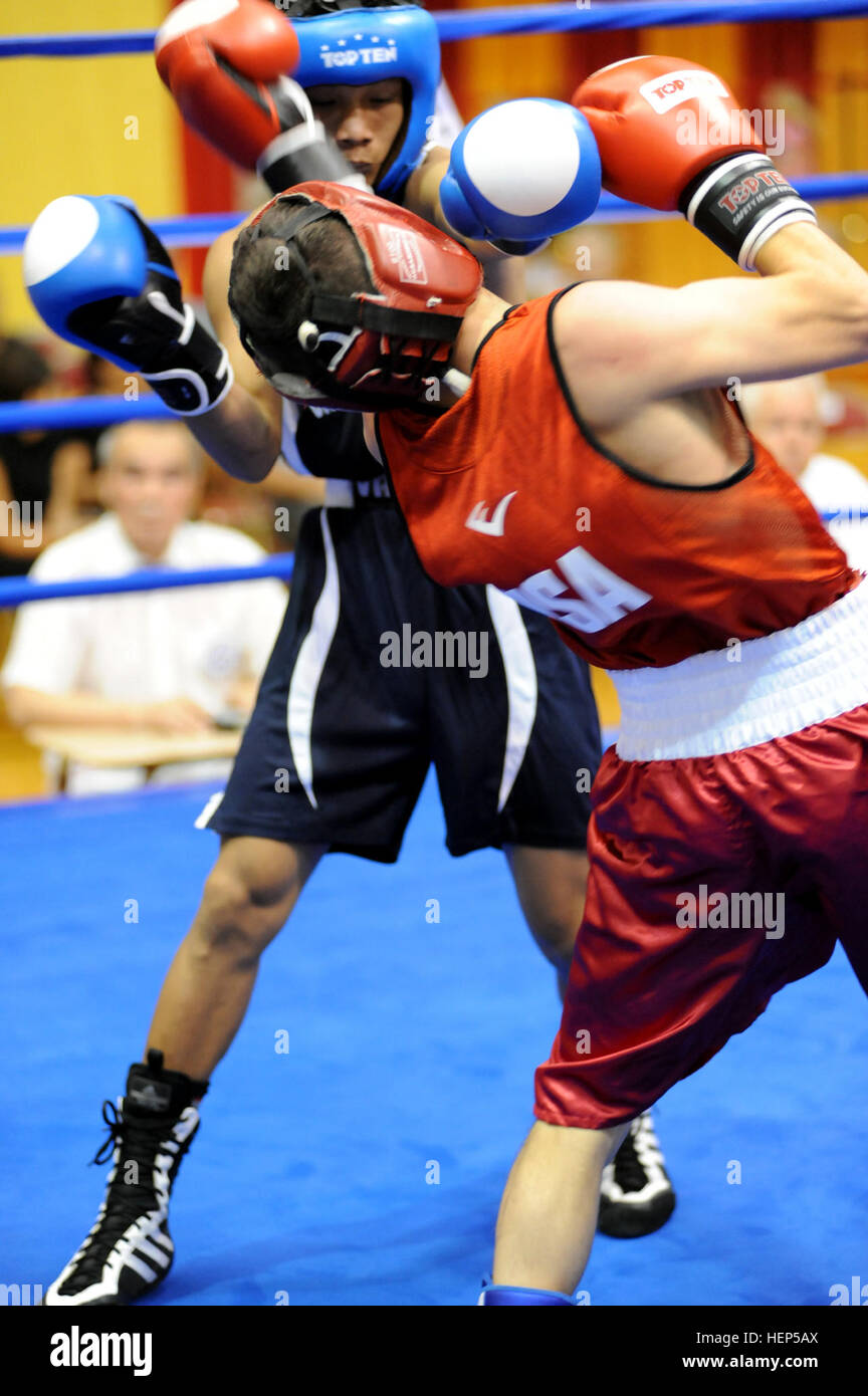 U.S. Army World Class Athlete Program boxer Capt. Michael Benedosso (foreground in red) advances ...