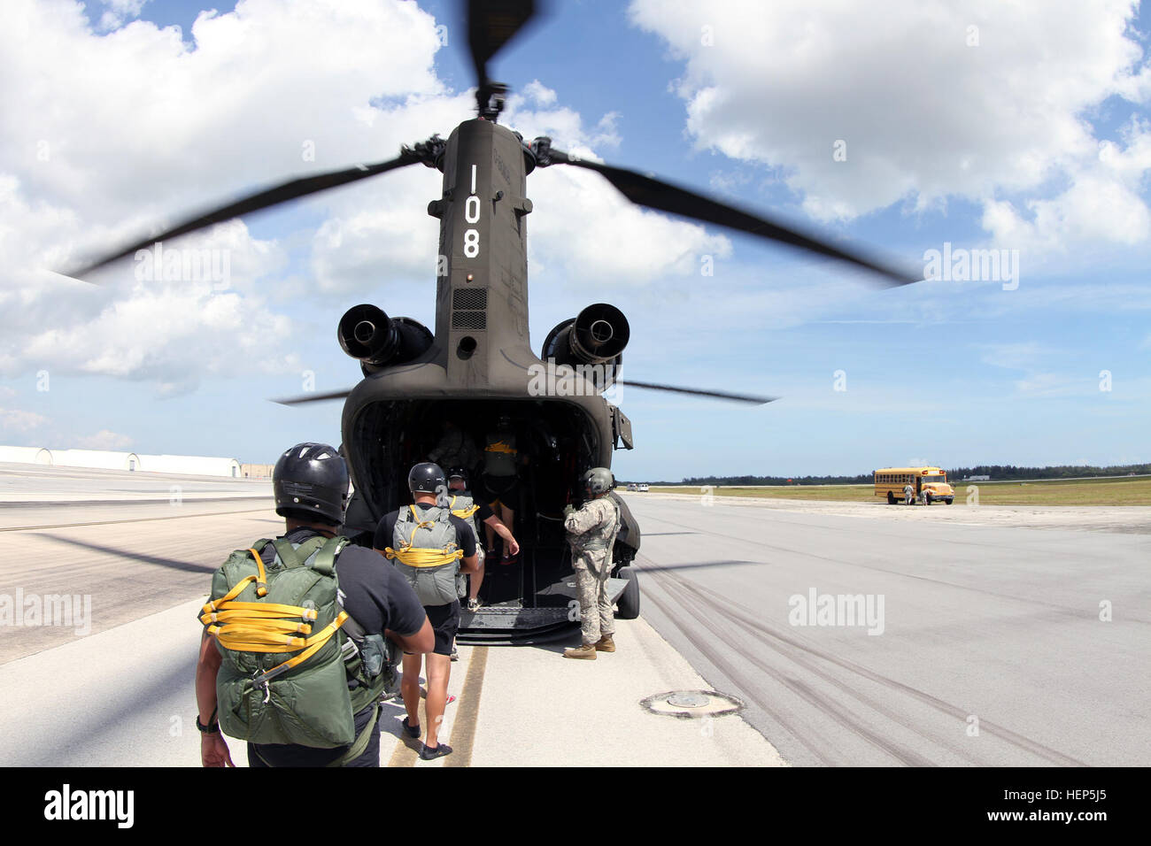 The blades of a CH-47 Chinook helicopter spin as airborne personnel ...