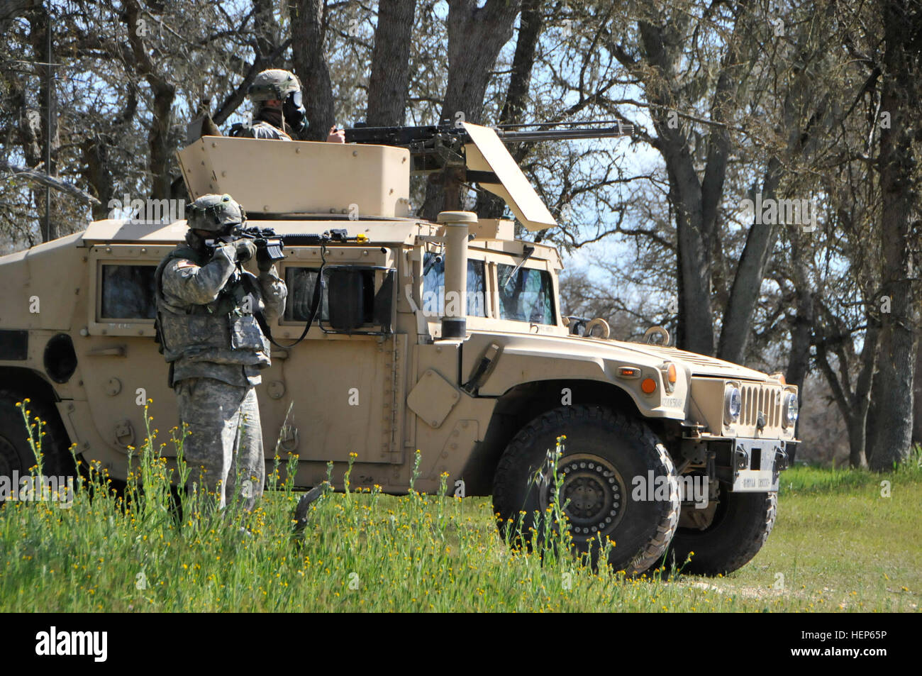 SPC Dalton Setterquist, standing next to the vehicle, and PV2 Chad ...