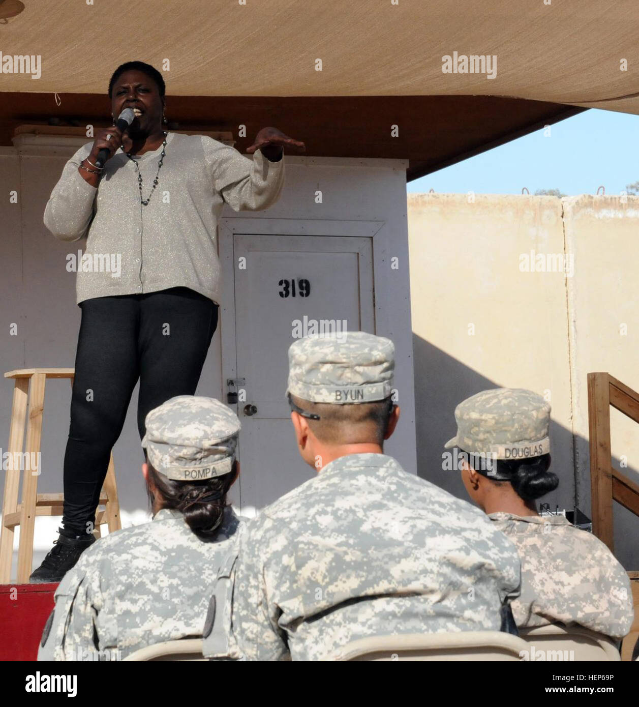 Comedienne Nikki Carr performs on an outdoor stage on Contingency ...