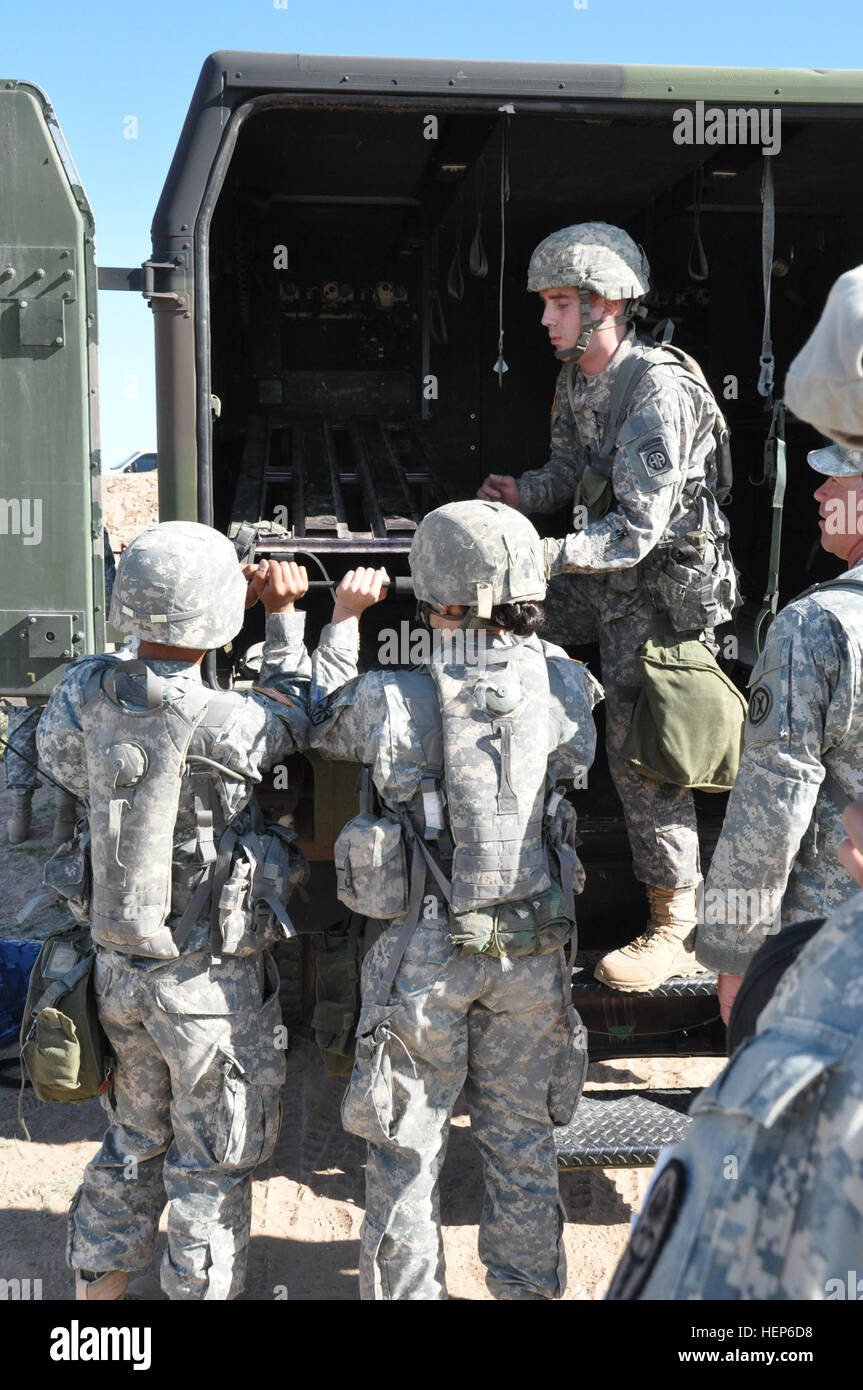 Candidates practice litter loading on an ambulance. There are several ...