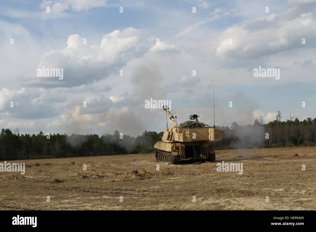 An M109 Paladin 155mm self-propelled howitzer fires a low angle ...