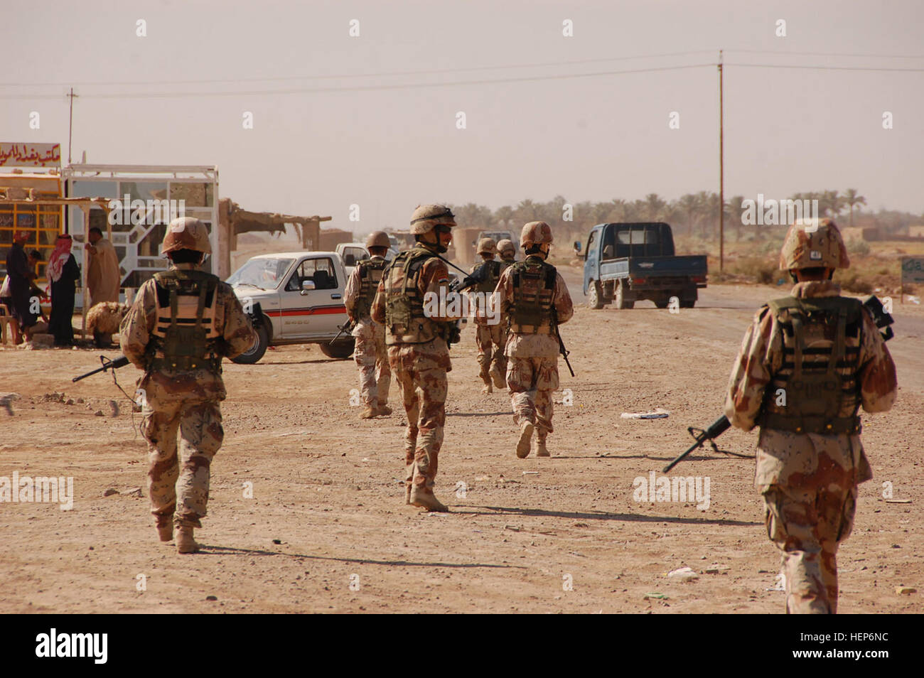 Iraqi army soldiers lead a foot patrol with Soldiers of Company A, 1st Battalion, 27th Infantry ...