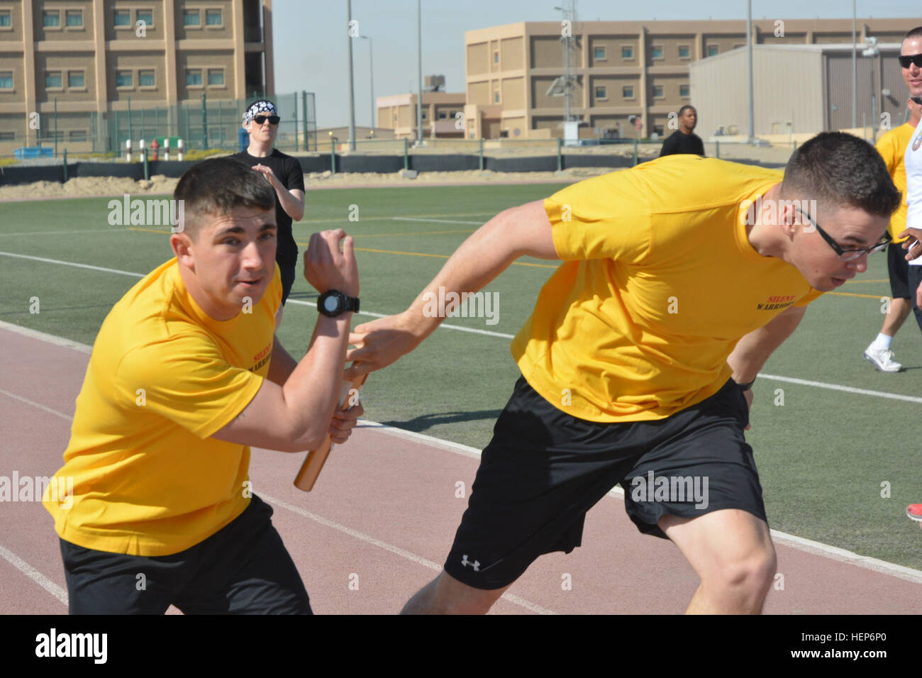 Spc. Robert Smith gets the baton hand off from Spc. Charles Wendt, both ...