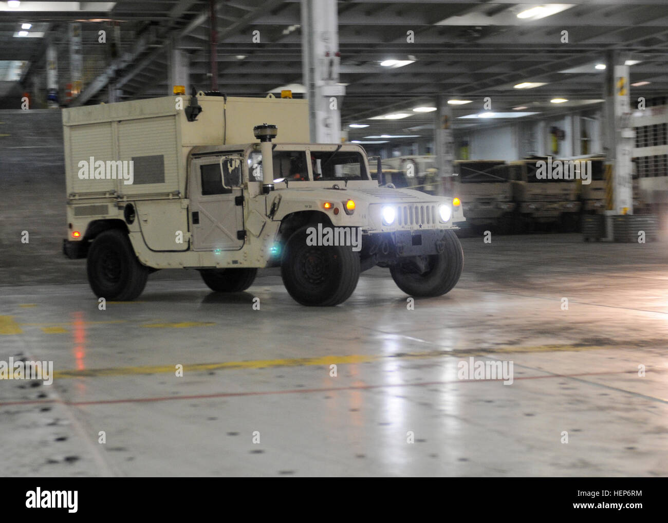 International logisticians offload a variant of the Humvee from the ...