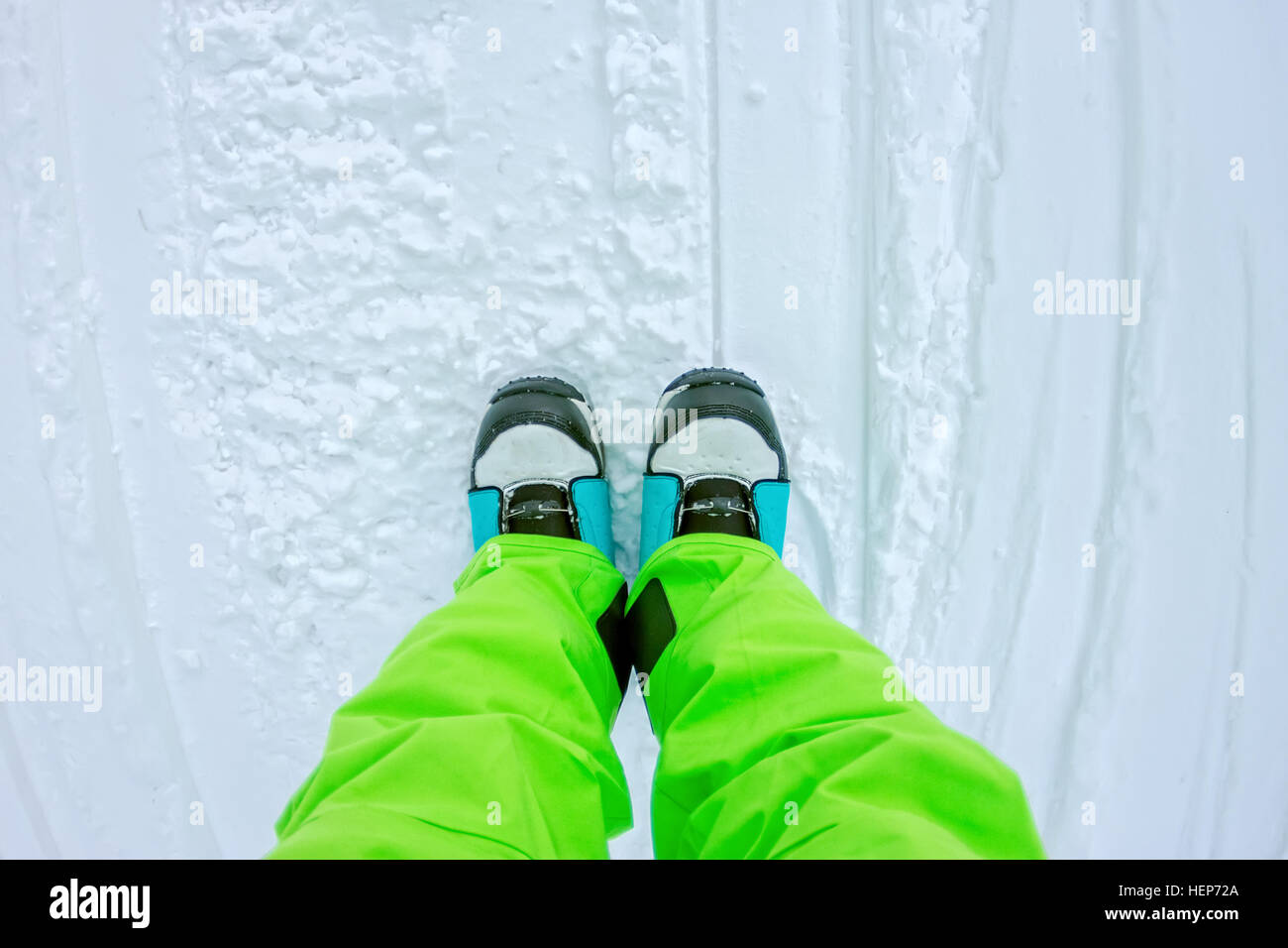 Top view of a foot in the snowboard boots and bright pants Stock Photo ...