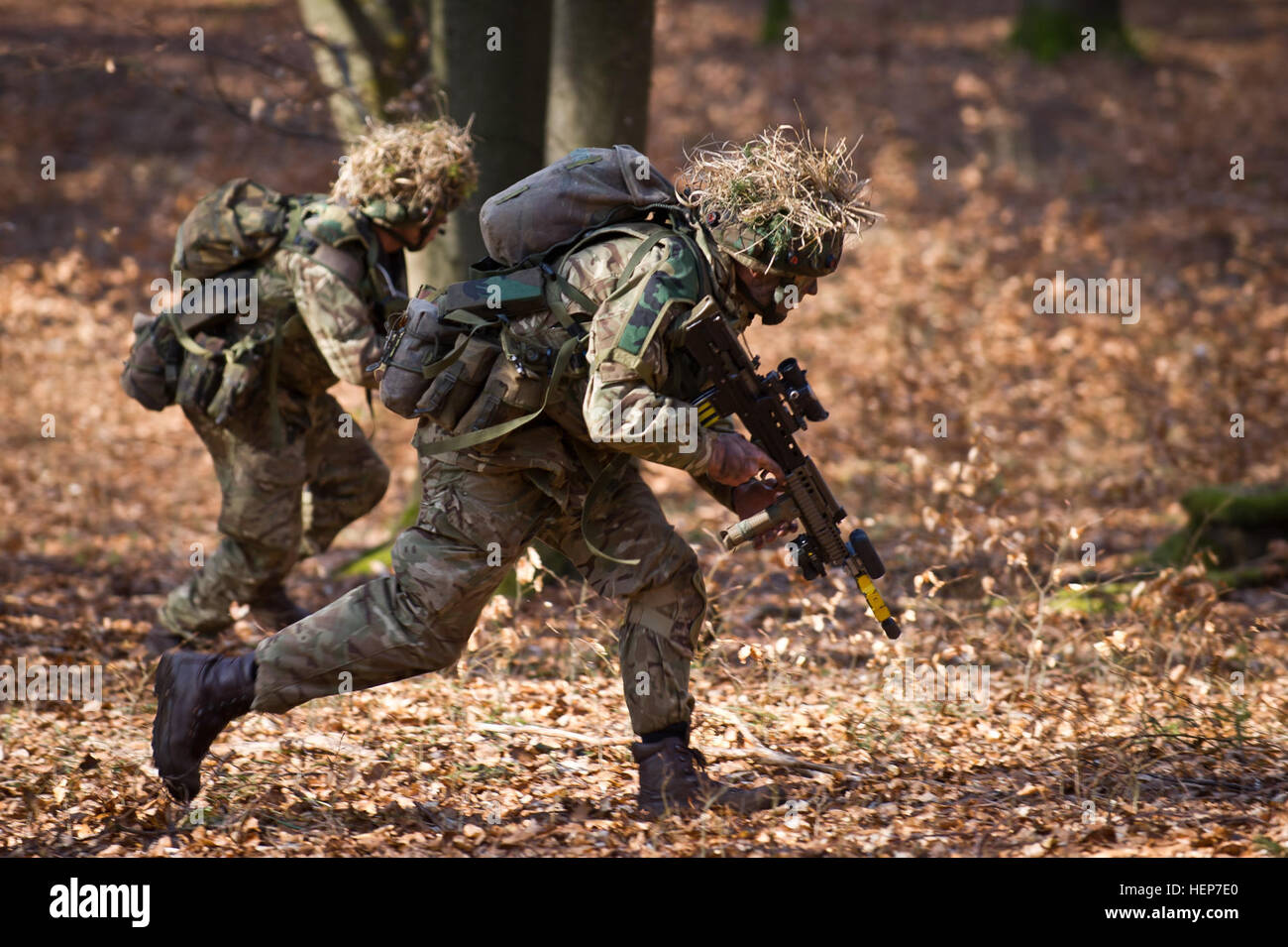 British cadets of the Royal Military Academy Sandhurst run to safety ...