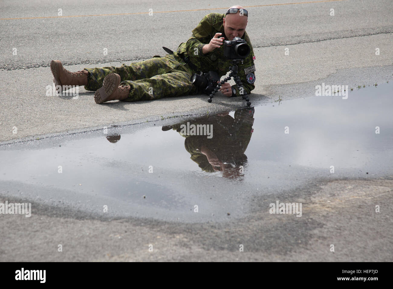 A Canada Armed forces combat camera member sets up a camera for a time ...
