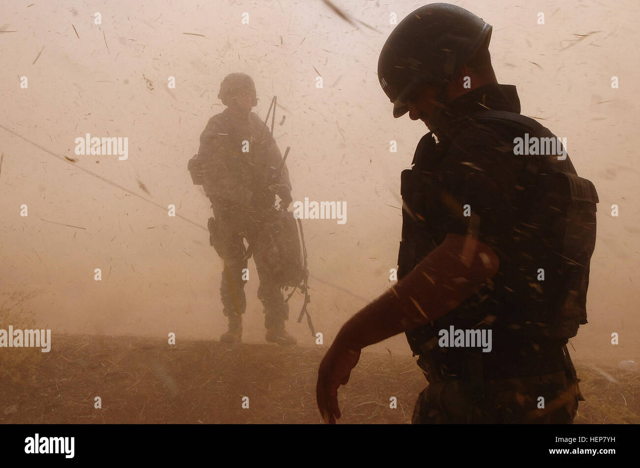 The rotor wash from a UH-60 Blackhawk helicopter temporarily blinds an ...
