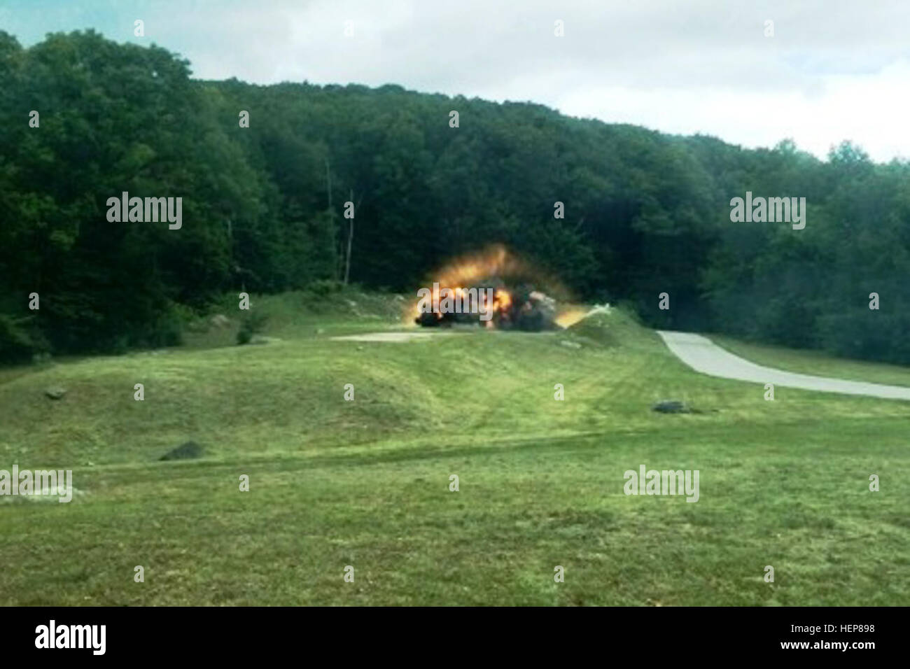 A Bangalore torpedo explodes against a mine-wire obstacle at West Point ...