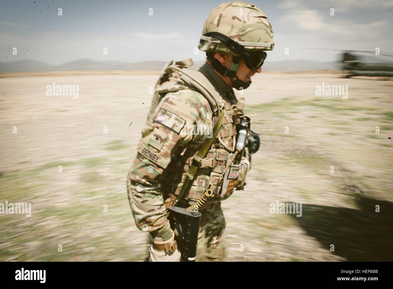 British army Brig. Felix Gedney moves to board a Chinook helicopter ...