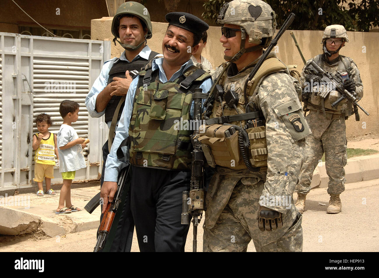 U.S. Army 1st Lt. Ryan Chang and Iraqi Police Lt. Akil bond during a ...