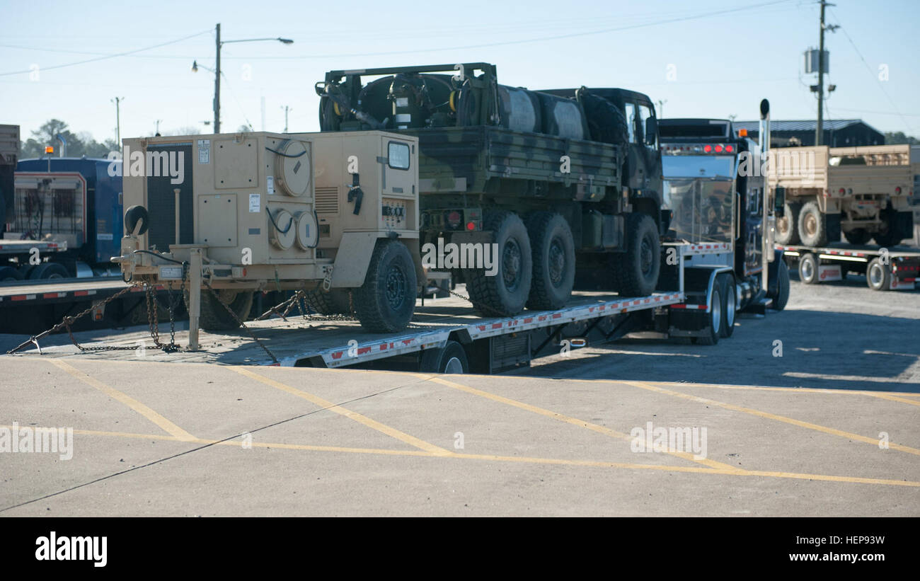 Tractor-trailers transport equipment back to an unloading area from a ...