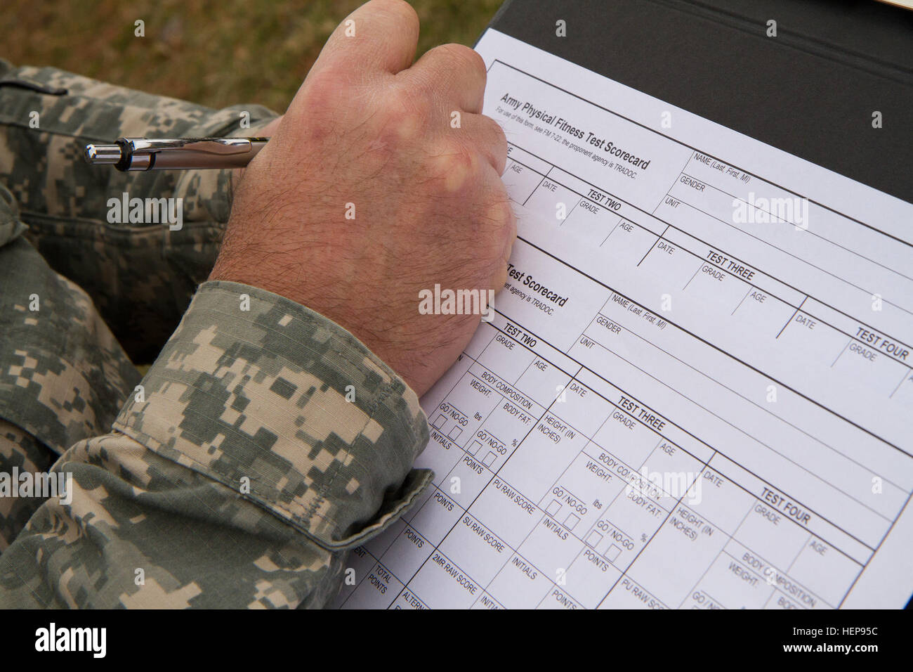 A Soldier fills out the Army Physical Fitness Test scorecard during day ...