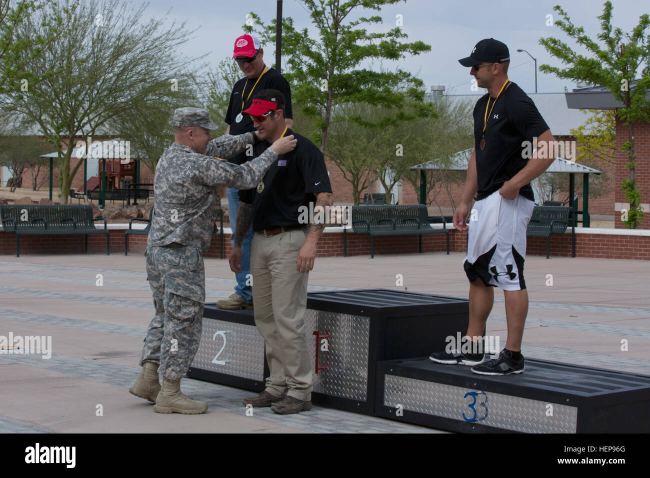 Warrior Transition Command, Command Sgt. Maj. Matthew Brady, awards the ...