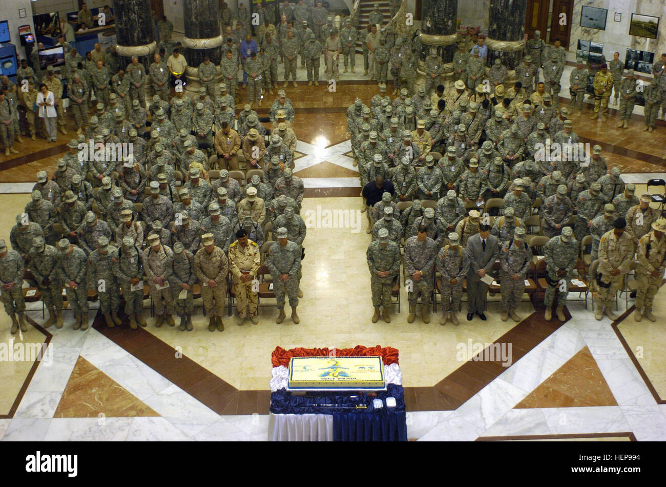Service members from Camp Victory, Baghdad, bow their heads during the ...