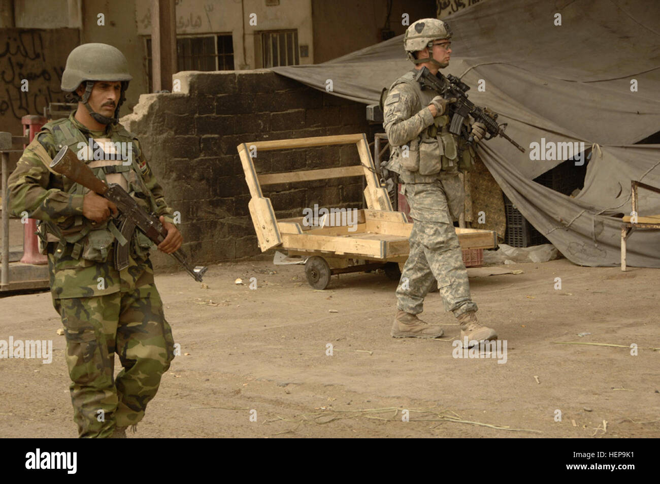 U.S. Army Staff Sgt. Nicholas Albert and an Iraqi army soldier conduct ...