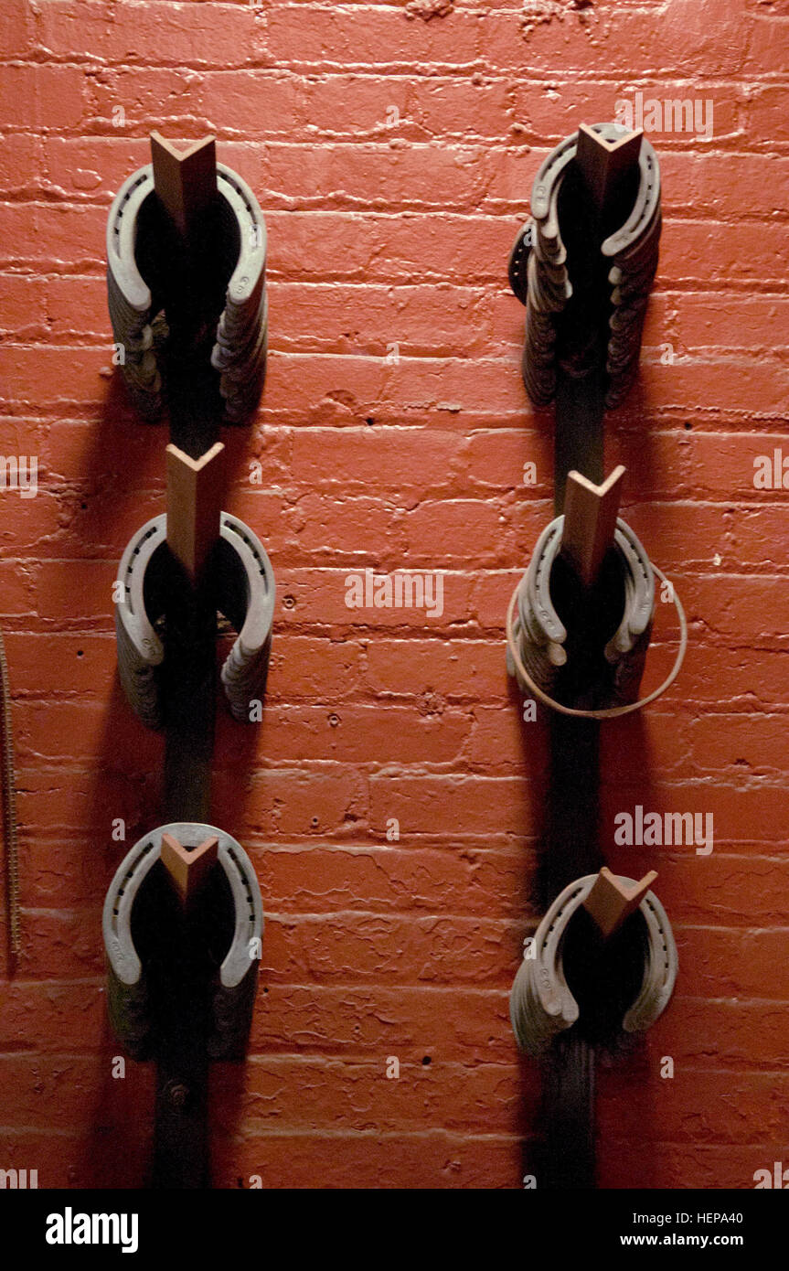 Finished horseshoes hang on a brick wall inside the Caisson Platoon ...