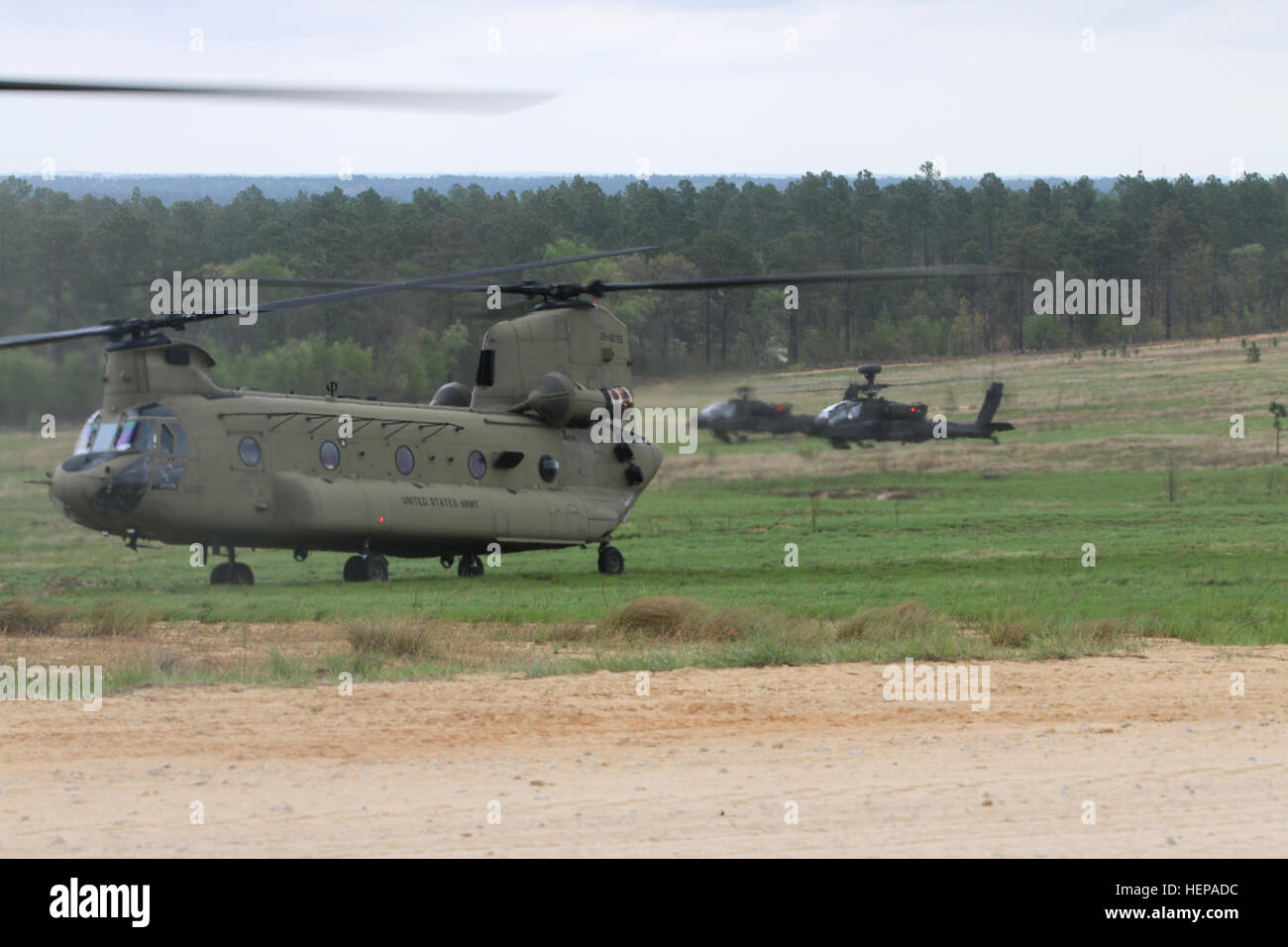 A CH-47 Chinook helicopter and two AH-64 Apache helicopters from 10th ...
