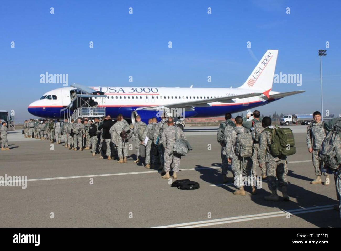 Soldiers from the 40th Combat Aviation Brigade board a plane in Fresno ...