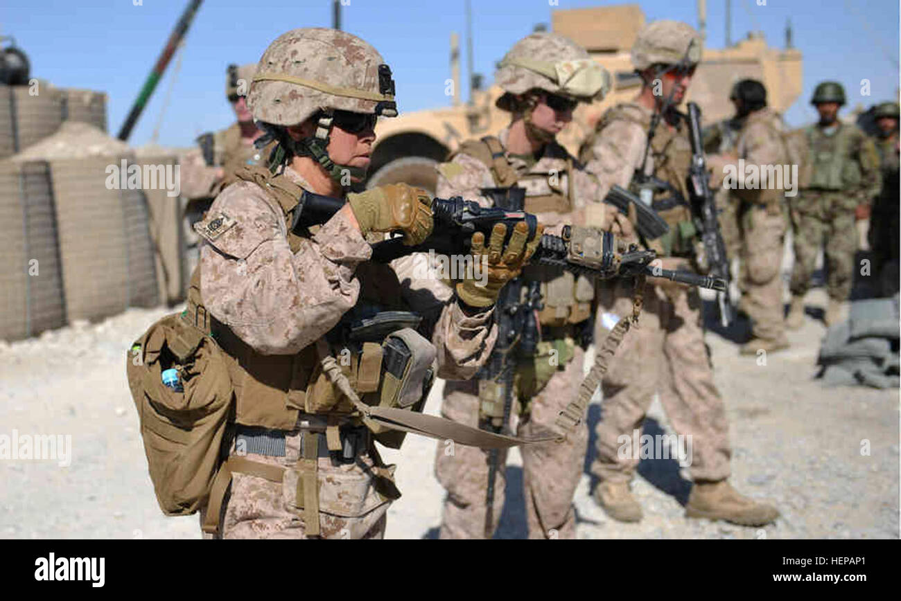 Female Marines check their rifles after a patrol with Afghan soldiers ...