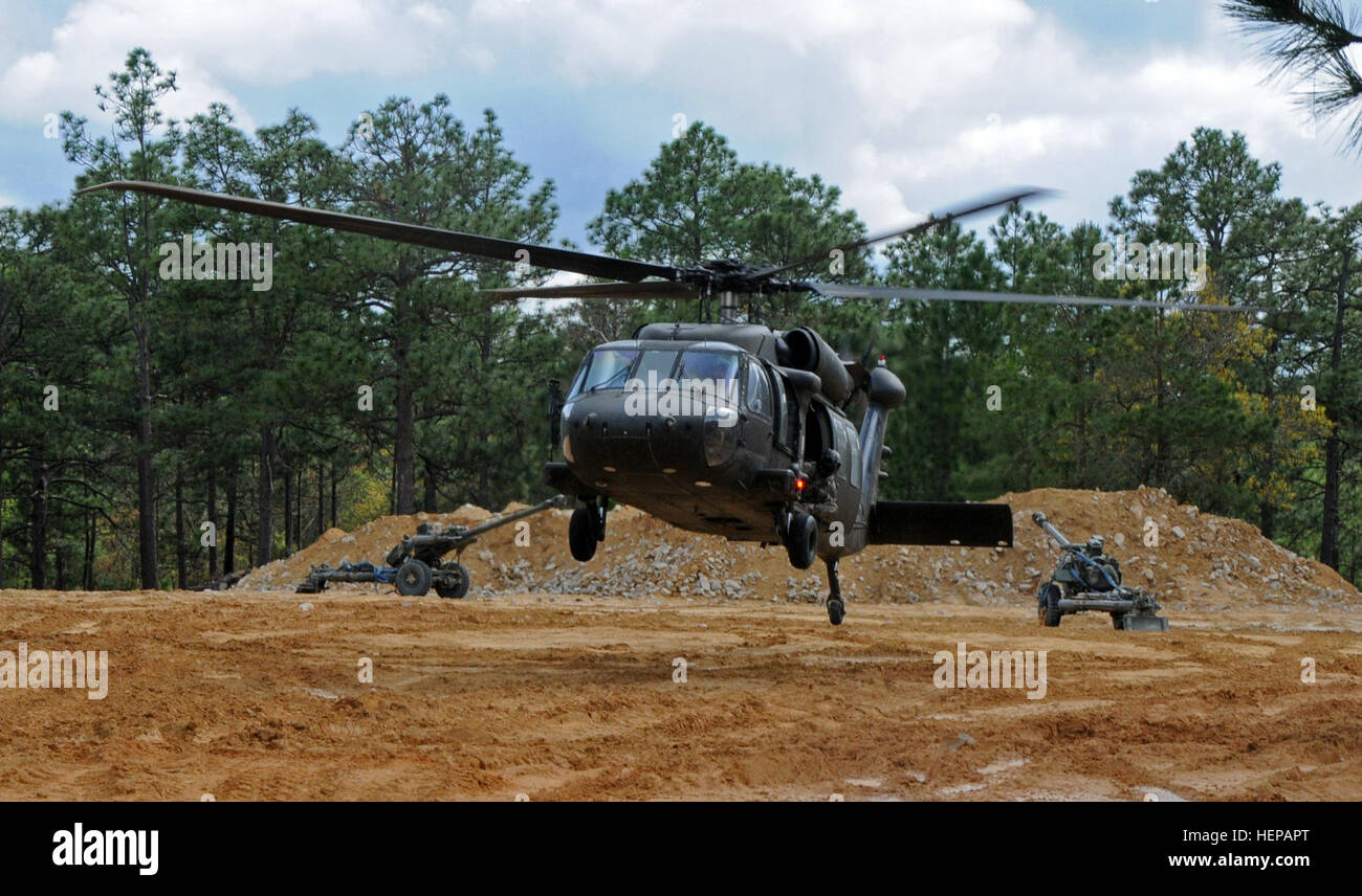 UH 60s sling load two British L118 light guns dropping them and the ...