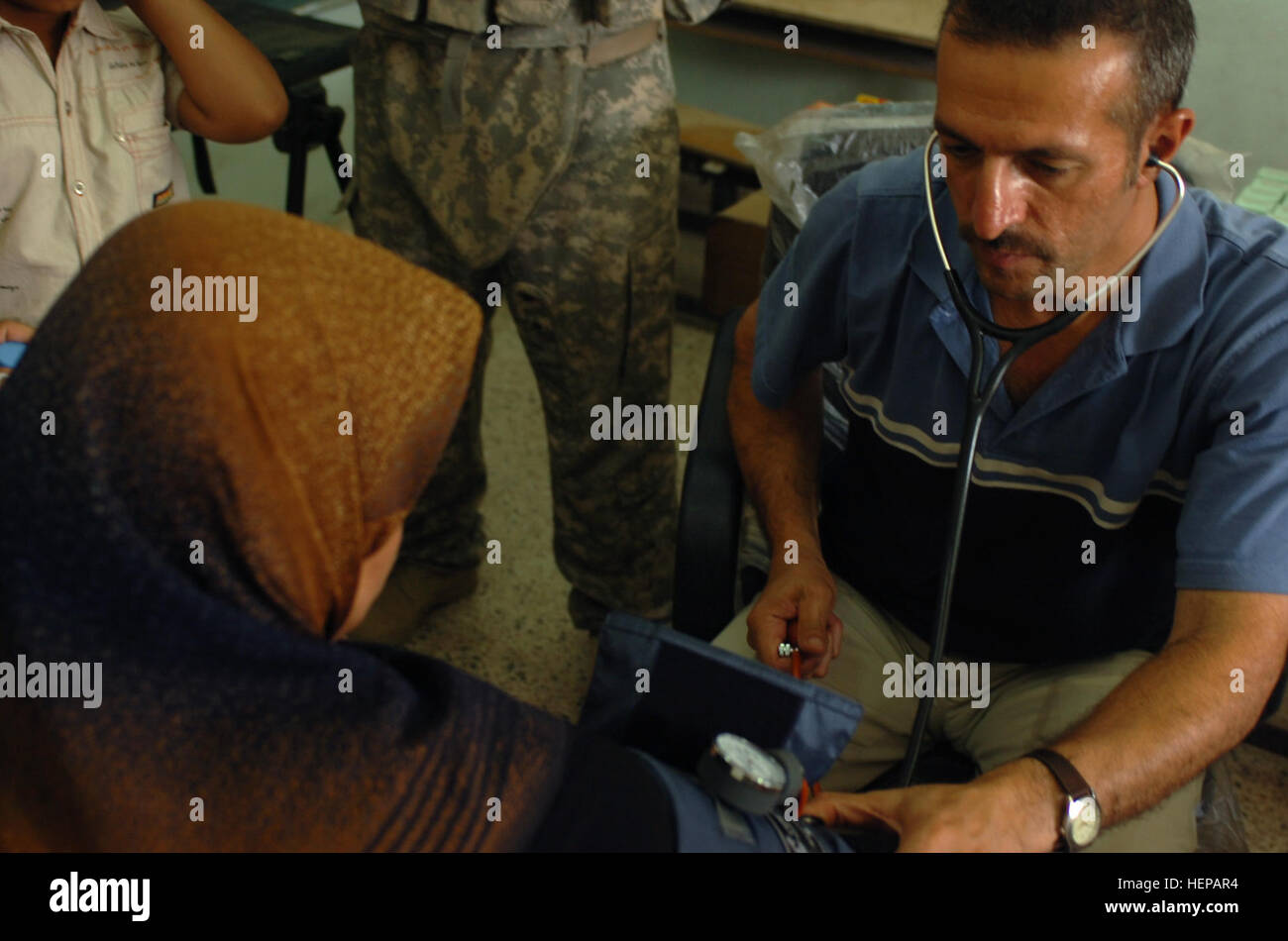 Dr. Yousif Yousif, an Iraqi physician, checks an Iraqi womans blood ...
