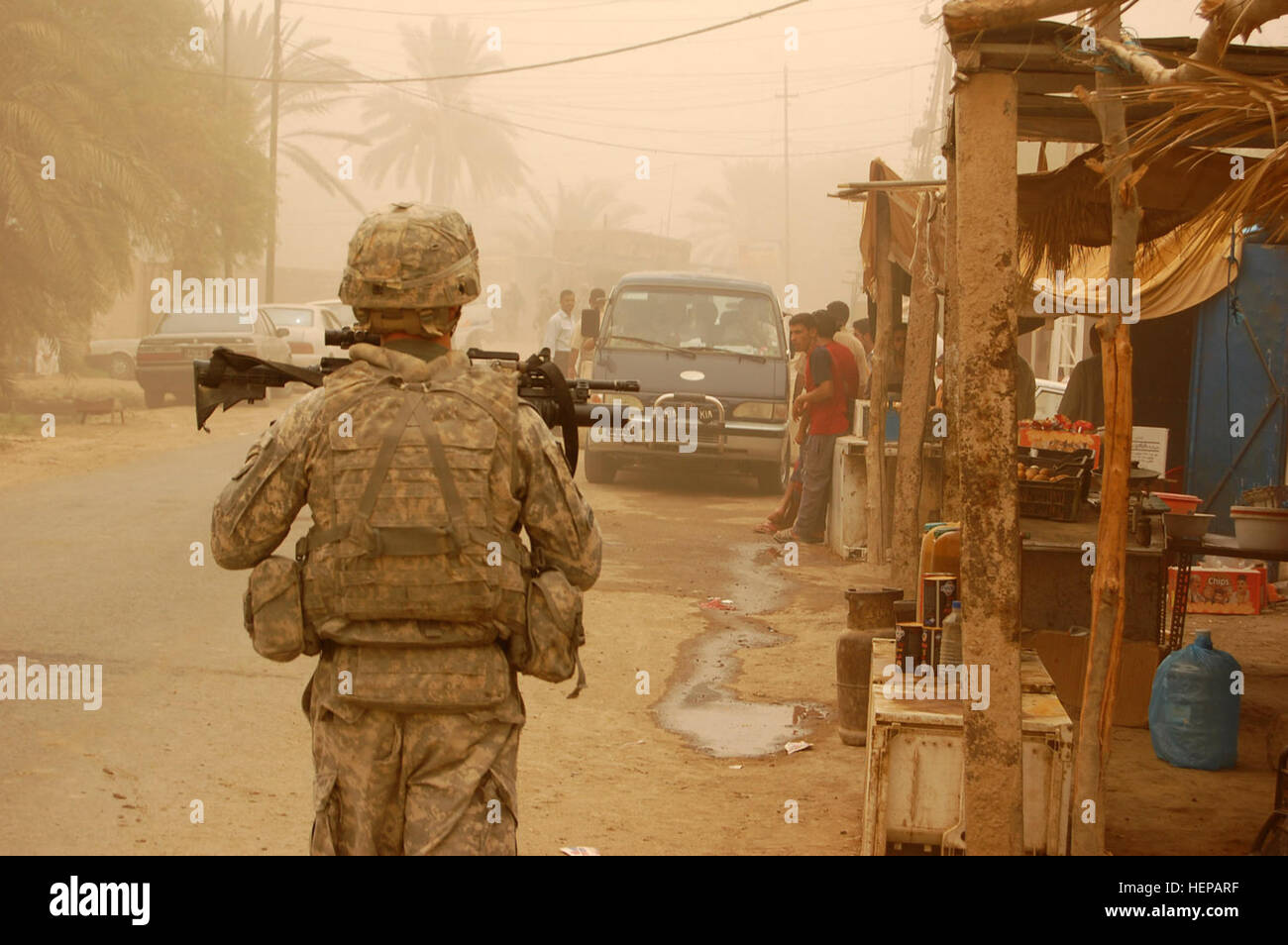 Sgt. Travis Stegmann, a native of Auburn, Ill., walks through a market ...