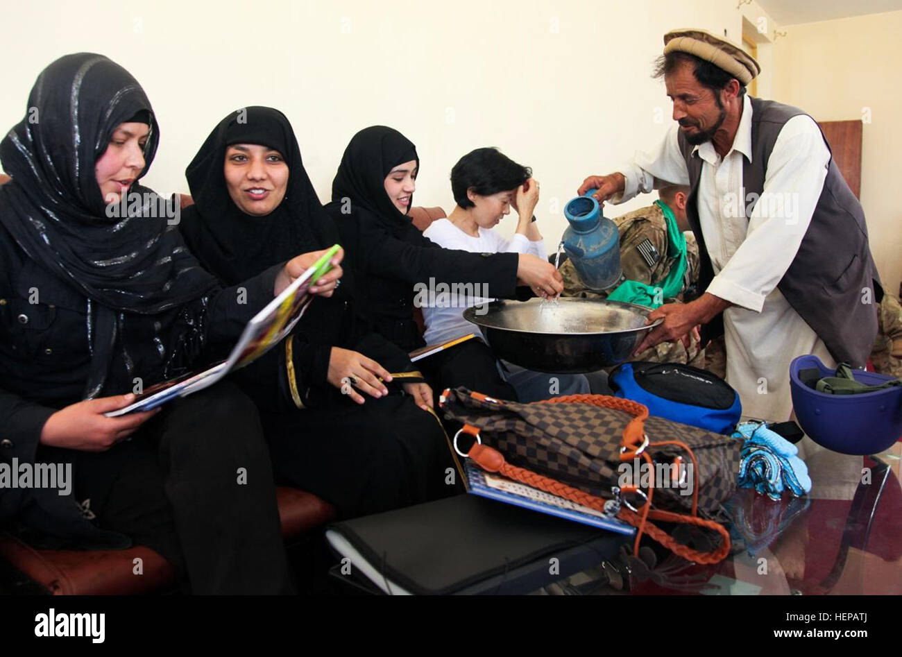 Afghan women wash their hands prior to sharing a meal with the Women’s ...