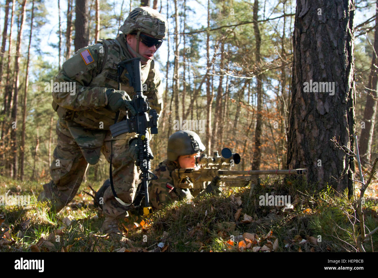 A Polish sniper provides cover for a U.S. Soldier from Headquarters and ...