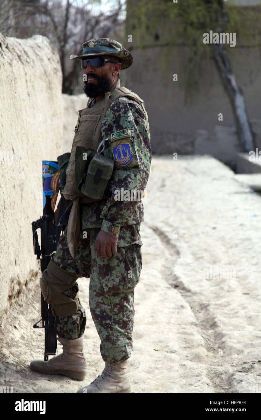 An Afghan National Army soldier provides security along a road in the ...
