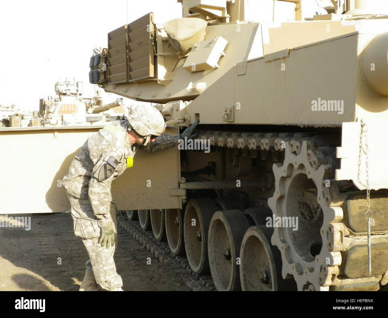 Soldiers from 2nd Battalion, 8th Cavalry Regiment inspect tank tracks ...